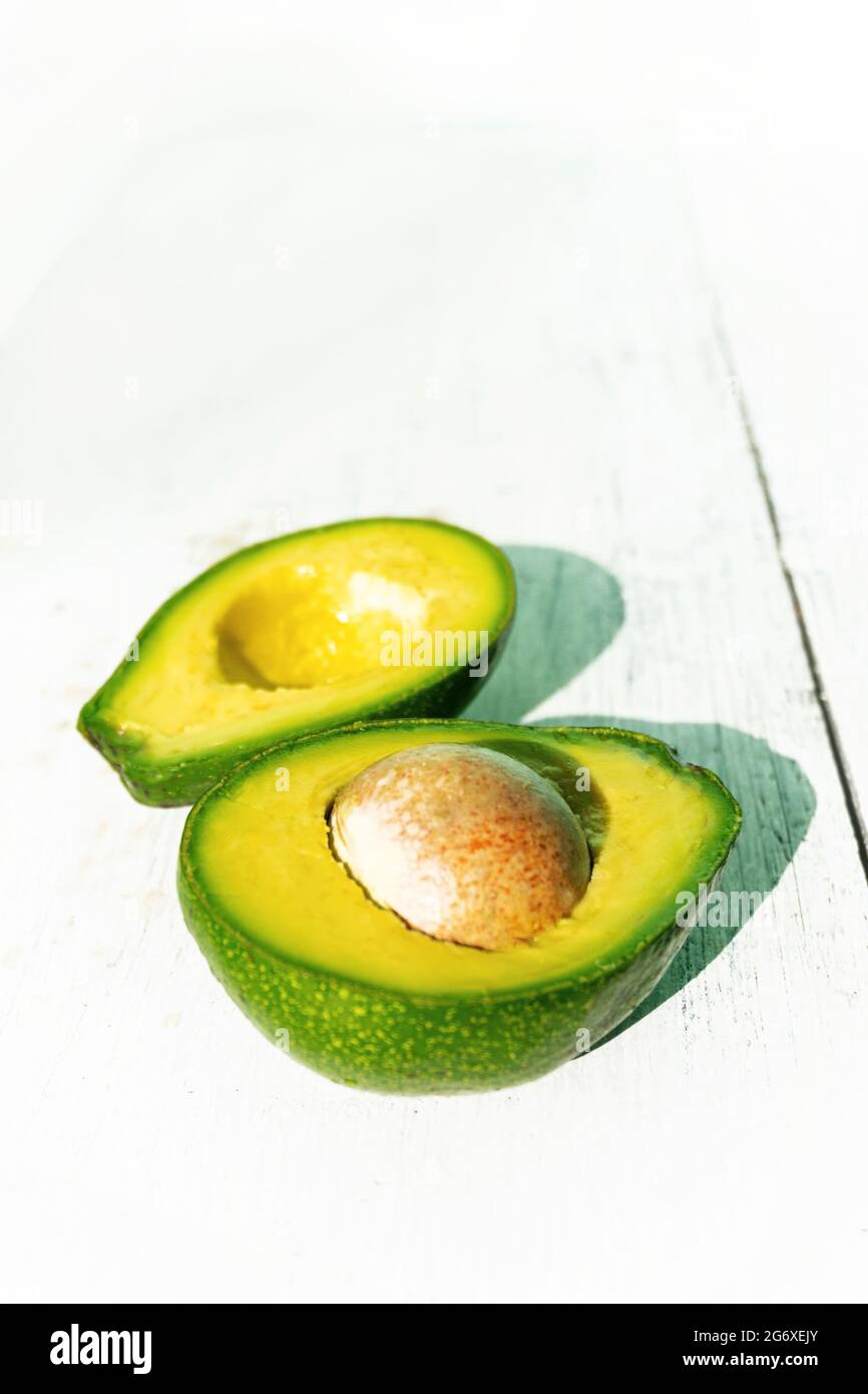 Avocado, tropical green fruit on a bright background, modern ...