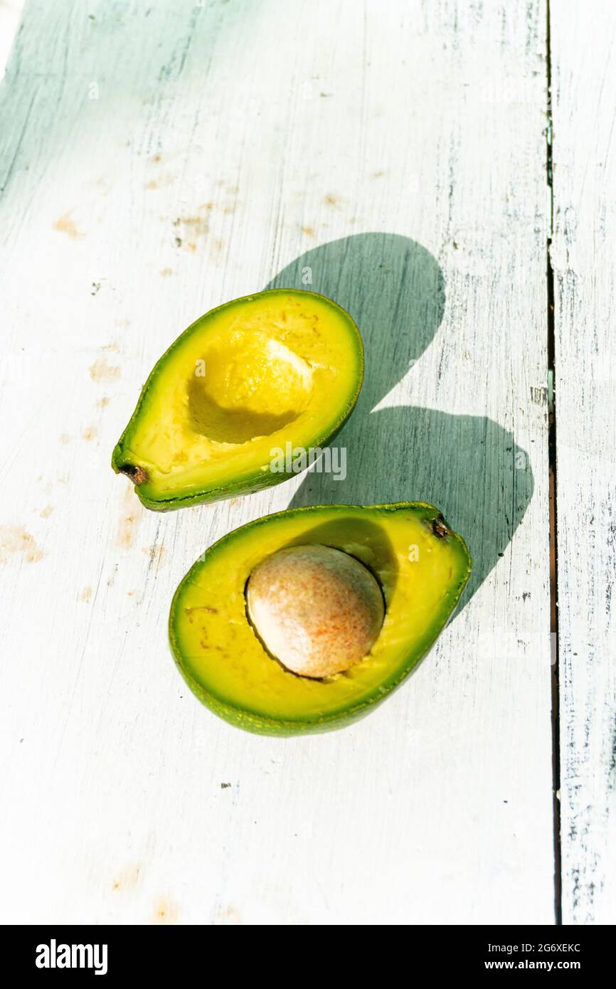 Avocado, tropical green fruit on a bright background, modern ...