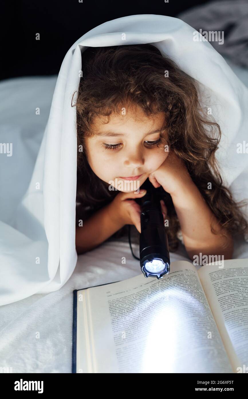 Boy under covers flashlight hi-res stock photography and images - Alamy