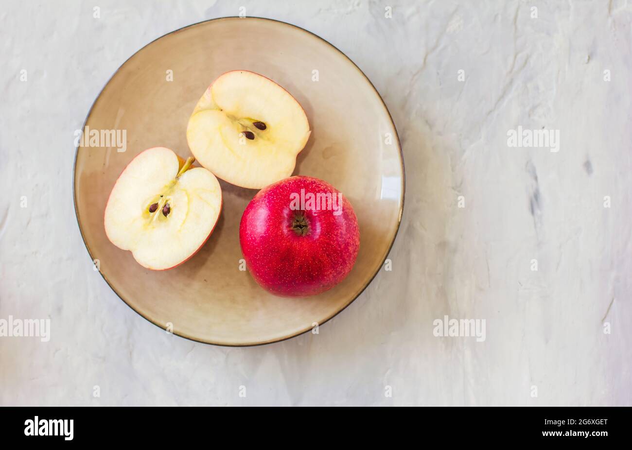 Apples and cups with plates on a grey background. Concept of healthy ...