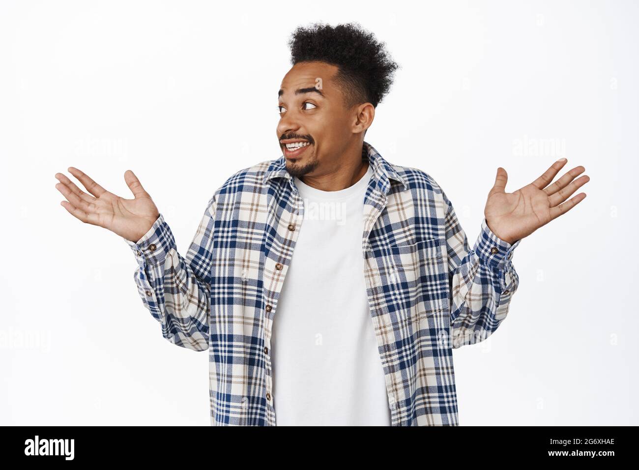 Oops awkward. Confused african american man shrugging shoulders ...