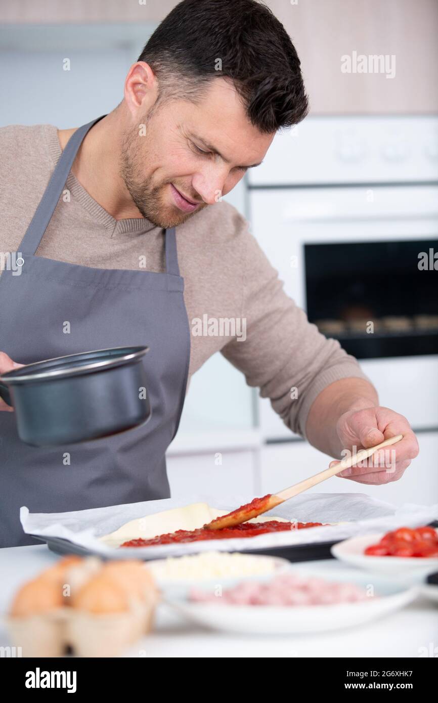 Chef adding cheese pizza hi-res stock photography and images - Alamy