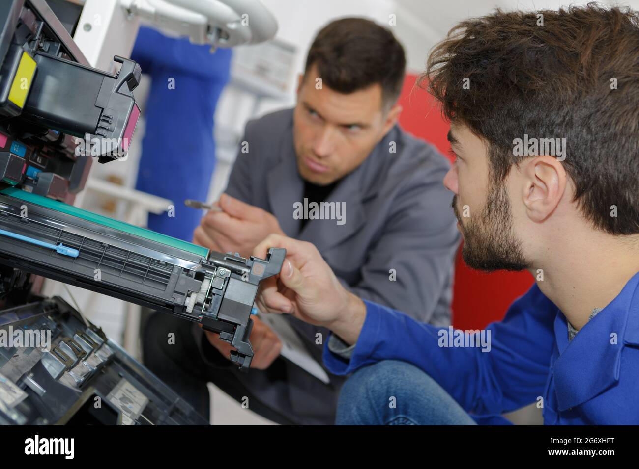 male technicians repairing a printer at business place at work Stock ...