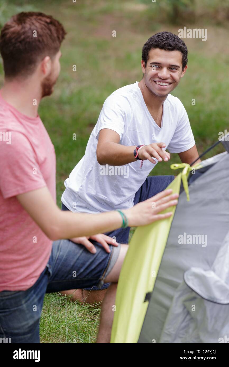 two handsome men camping in the woods Stock Photo - Alamy
