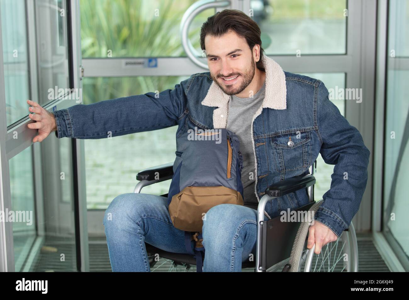 disabled man in wheelchair arriving at the office Stock Photo - Alamy