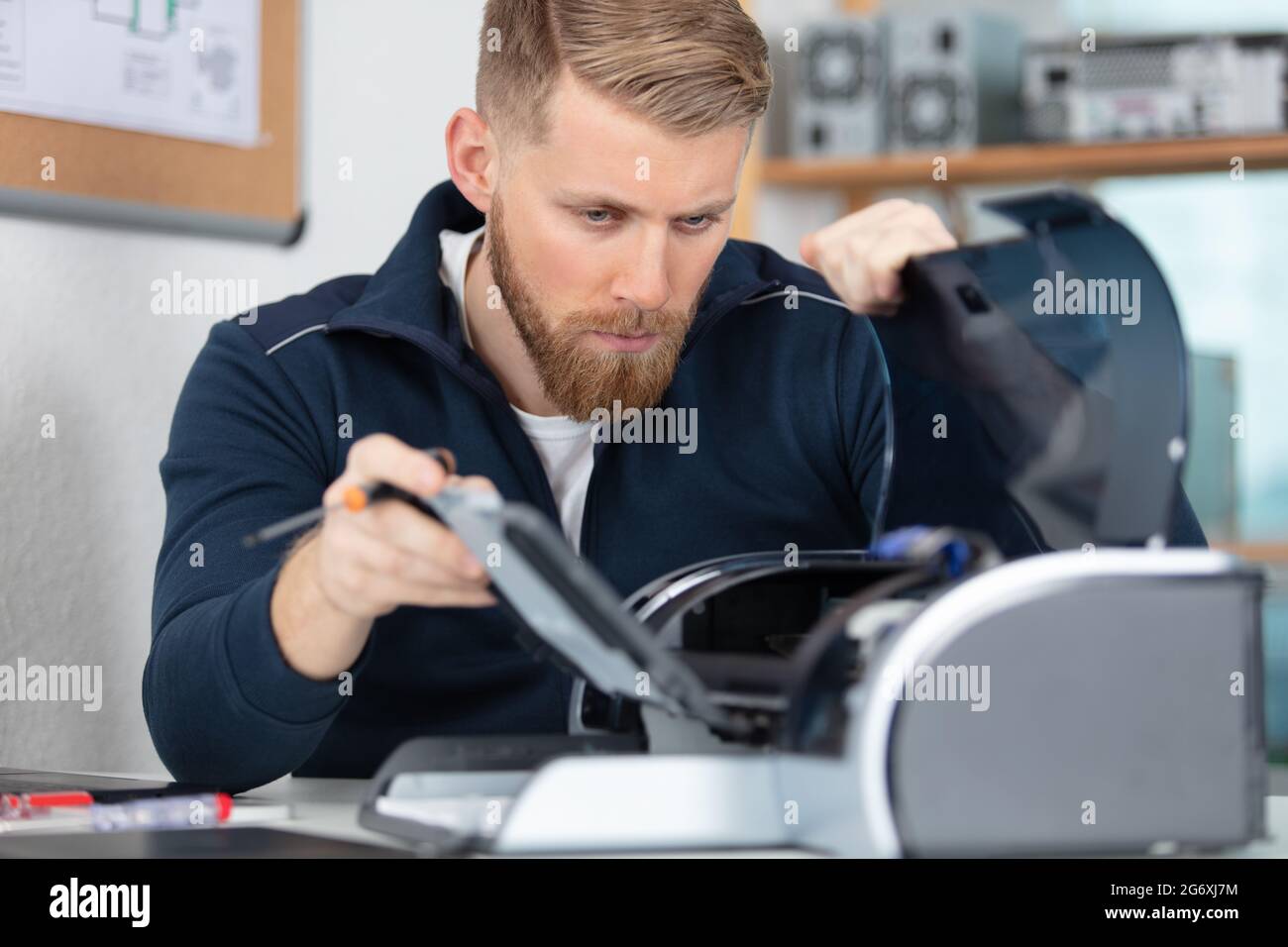 hardware repairman repairing broken printer fax machine Stock Photo - Alamy
