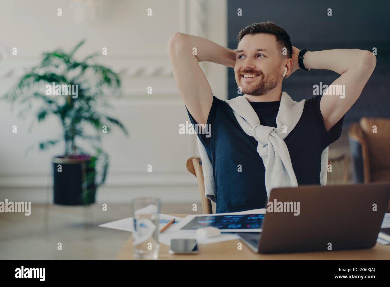 Happy businessman resting after work done at his cozy workplace in ...