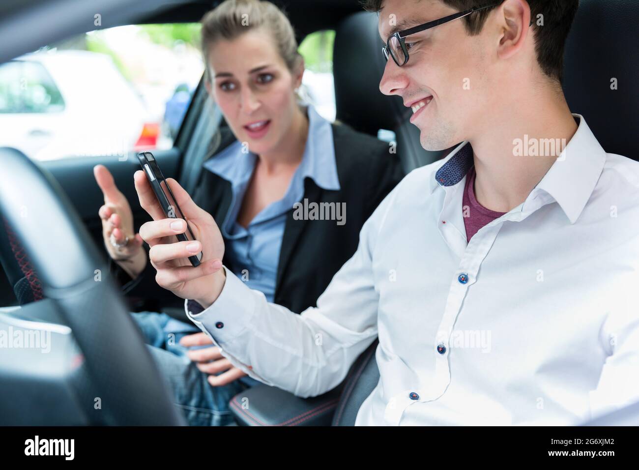 Driving instructor with student in car starting the engine Stock Photo ...