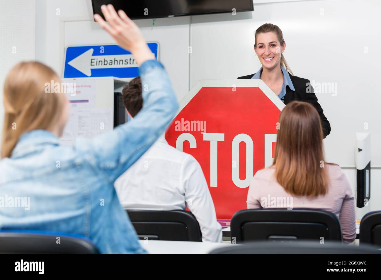 Teacher with class giving driving lessons explain traffic signs Stock ...