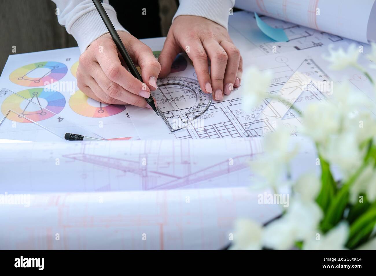 Hands use pencil with a protractor. Architectural Project drawings with ...