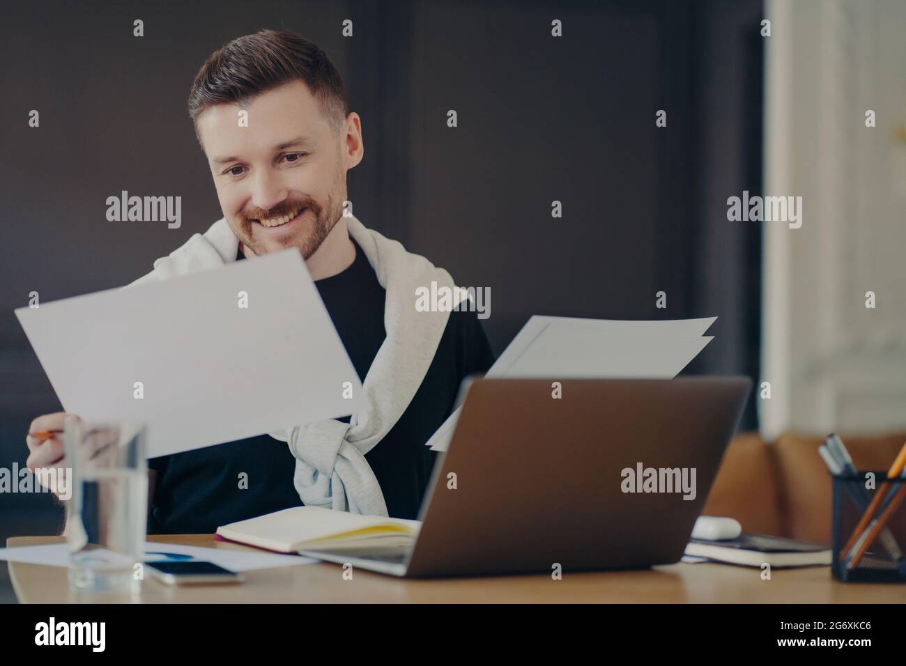 Successful businessman feeling happy with project results while working ...