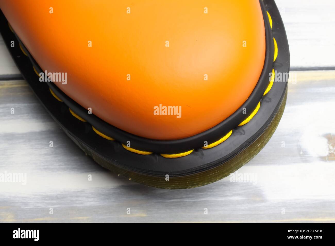 Closeup top view on bright orange color tip of one single leather boot ...