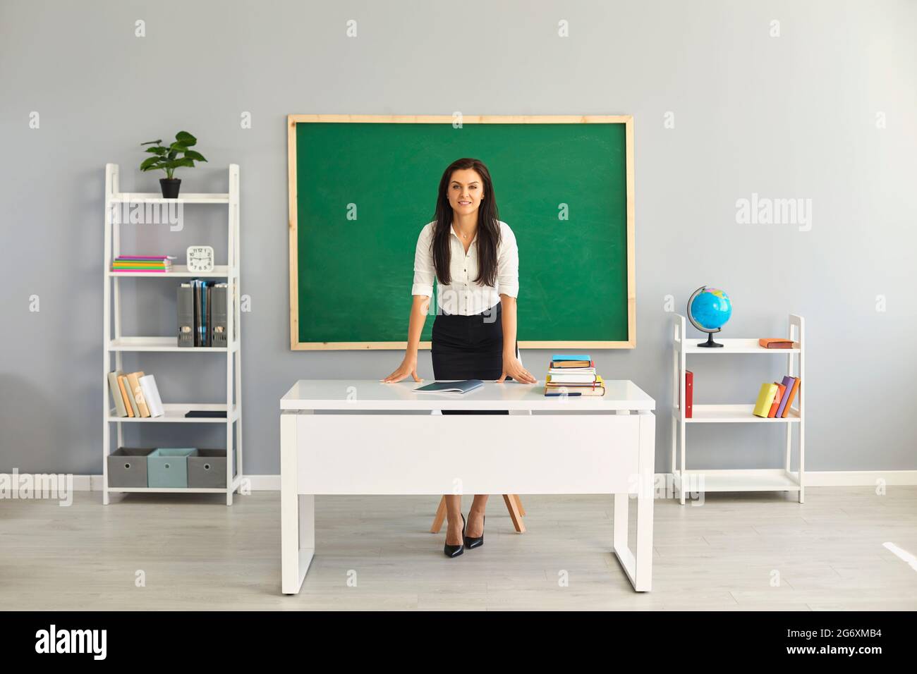 Woman teacher in classroom school college classroom Stock Photo - Alamy