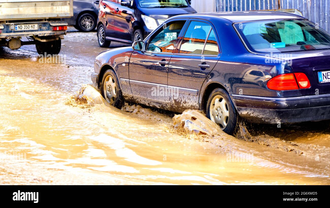 Batumi, Georgia - April 12, 2021: Car rides on a puddle Stock Photo - Alamy