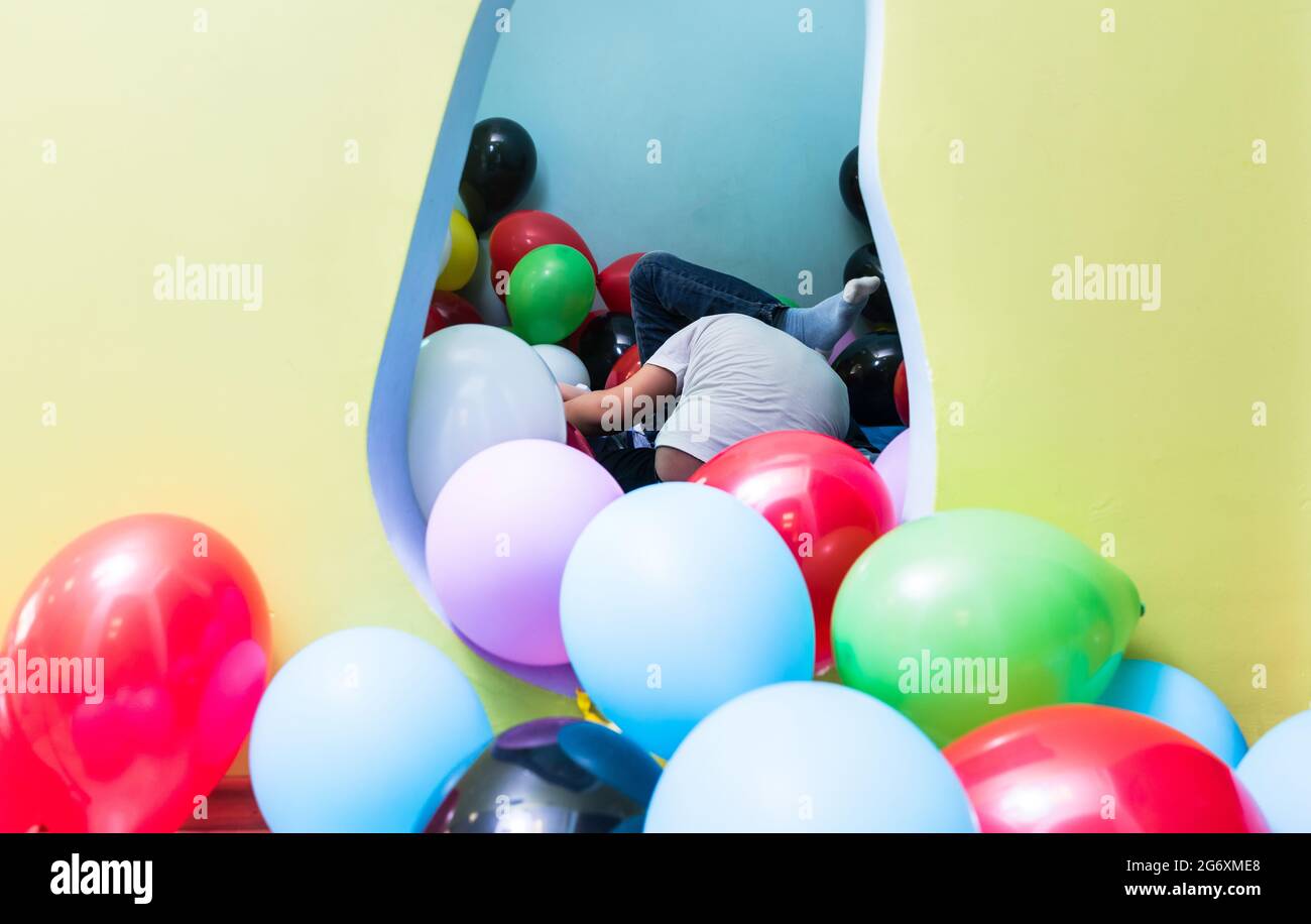 Two children playing balloons hi-res stock photography and images - Alamy