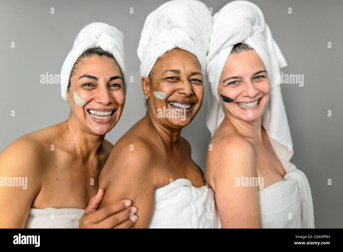 Happy multiracial senior women having skin care spa day - People ...