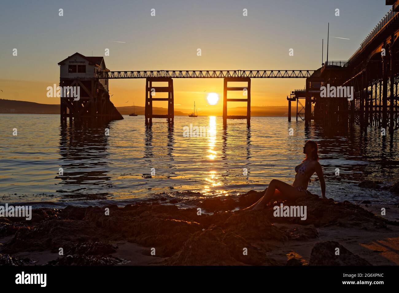 Pictured: Natasha Jenkins in the sea during sunrise as seen through the ...
