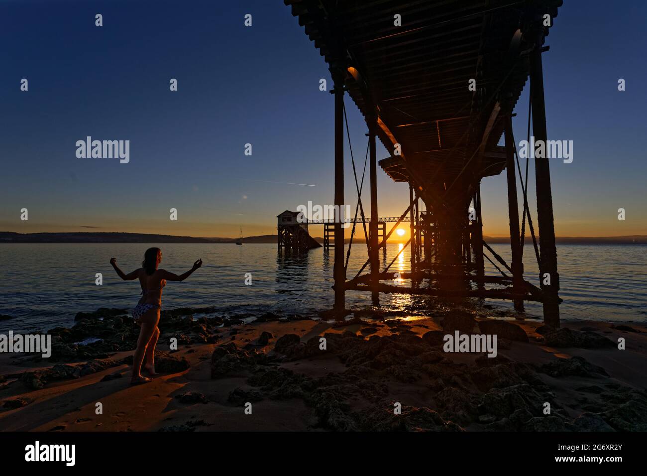 Pictured: Natasha Jenkins in the sea during sunrise as seen through the ...
