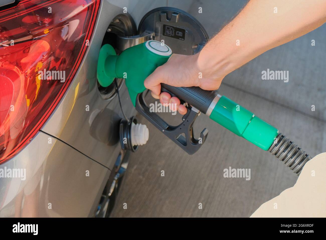 Hand holding gas fuel pump nozzle hi-res stock photography and images ...