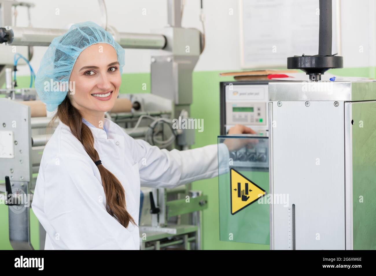 Close-up of the hand of a female manufacturing engineer adjusting the ...