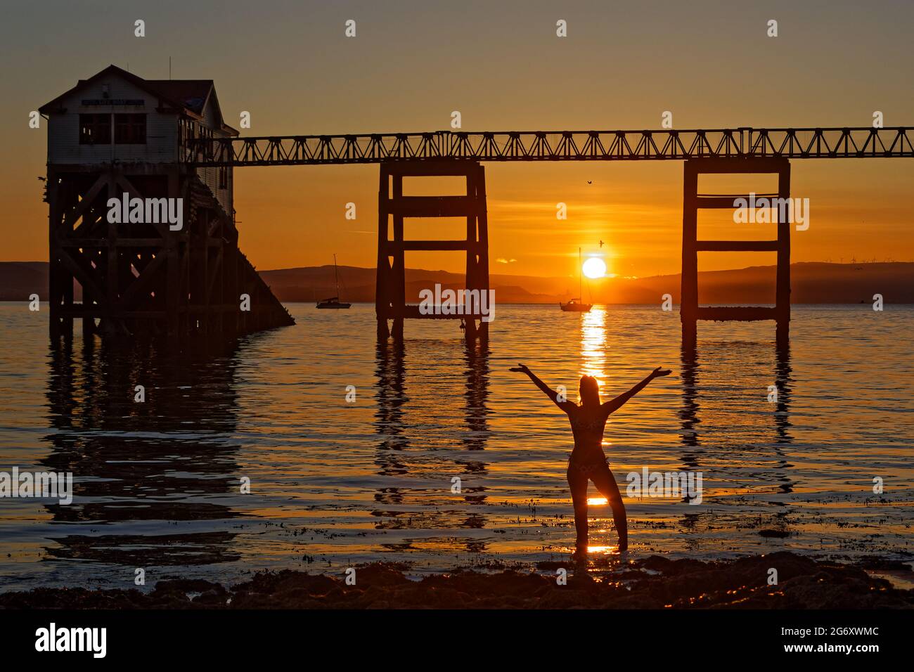 Pictured: Natasha Jenkins in the sea during sunrise as seen through the ...