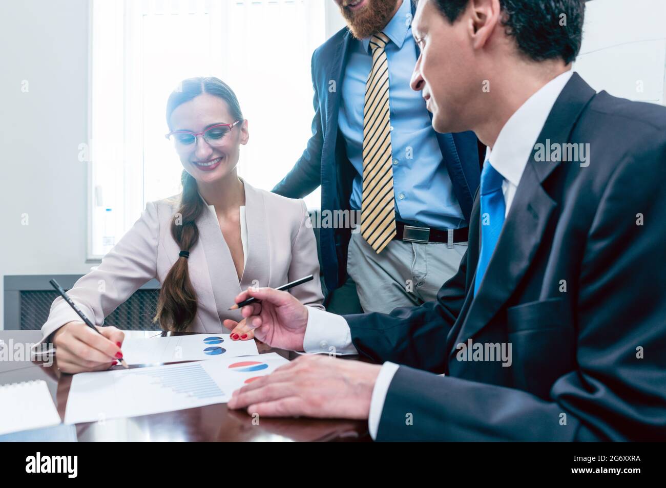Business analyst smiling while interpreting financial reports showing ...