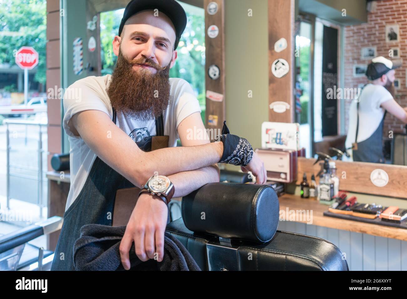 Portrait of a confident young barber smiling and looking at camera ... Portrait of a confident young barber smiling and looking at camera ...