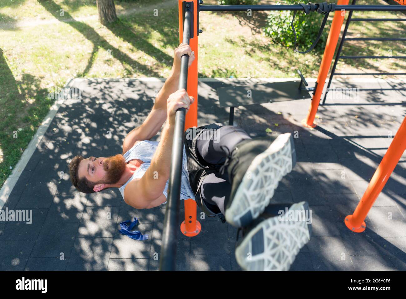 High-angle view of a strong and determined young man doing hanging ...