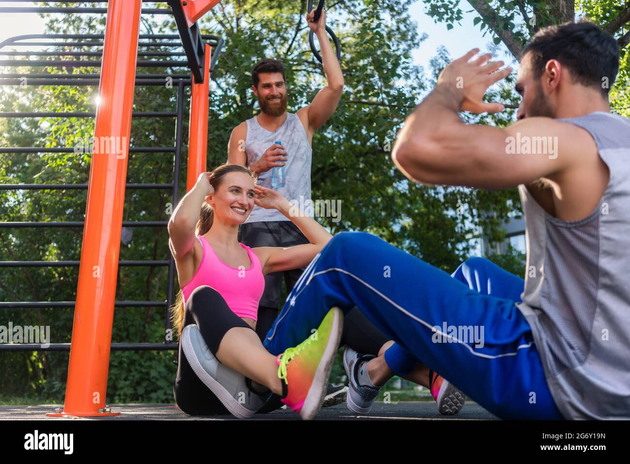 Low-angle view of an athletic couple clapping hands while doing ...