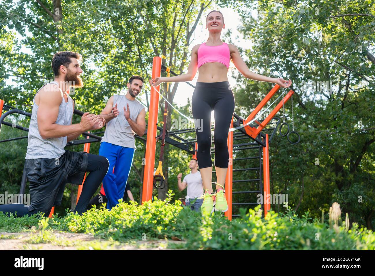 Low-angle view of a beautiful young woman jumping rope in the applauses ...