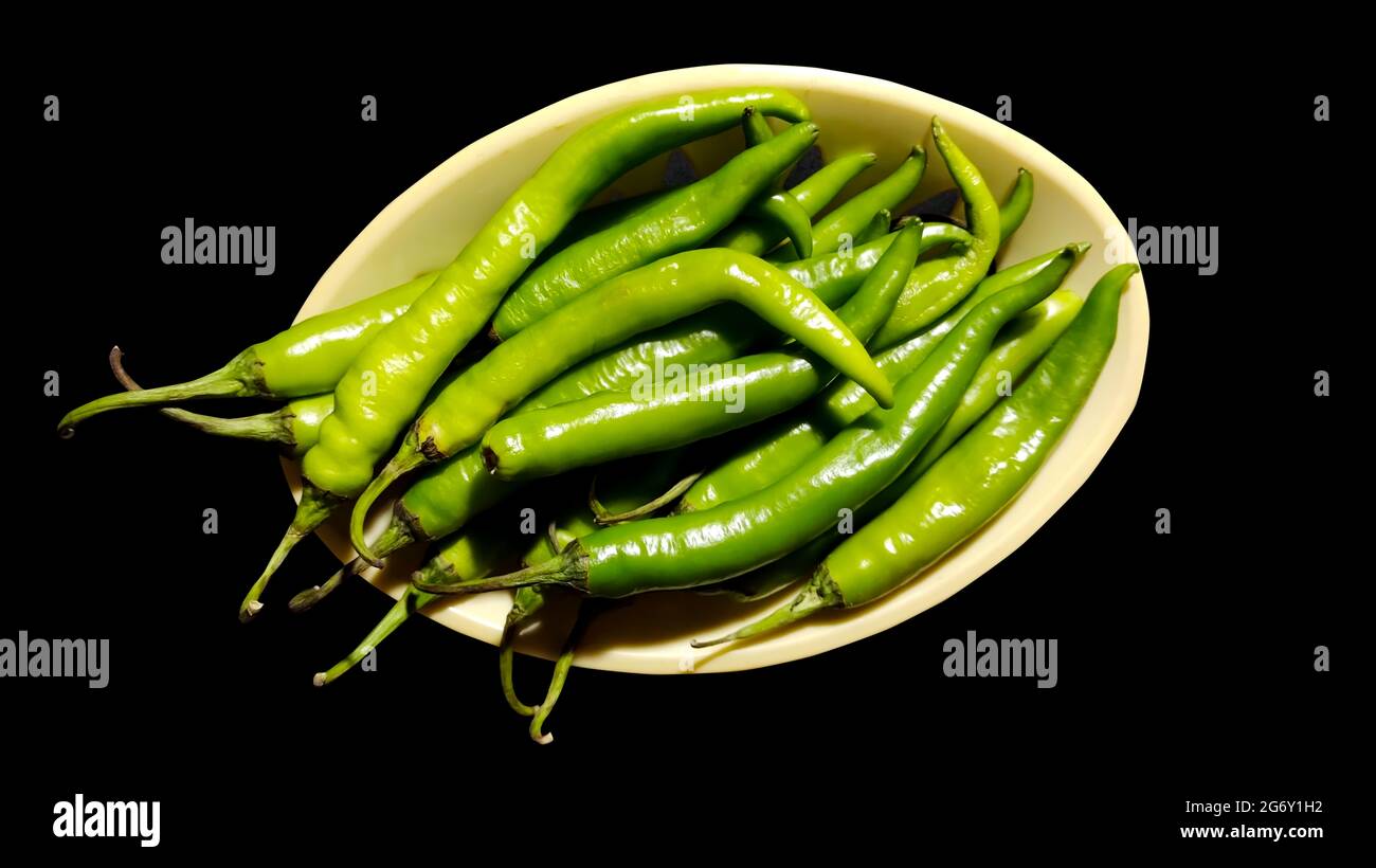 Fresh green chili on black background in india Stock Photo - Alamy