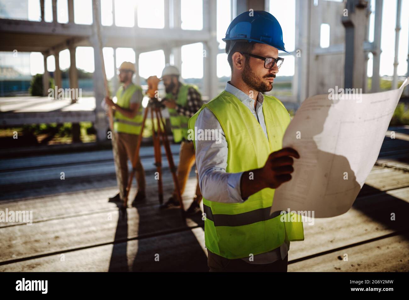 Architect and engineer construction workers working at outdoors ...