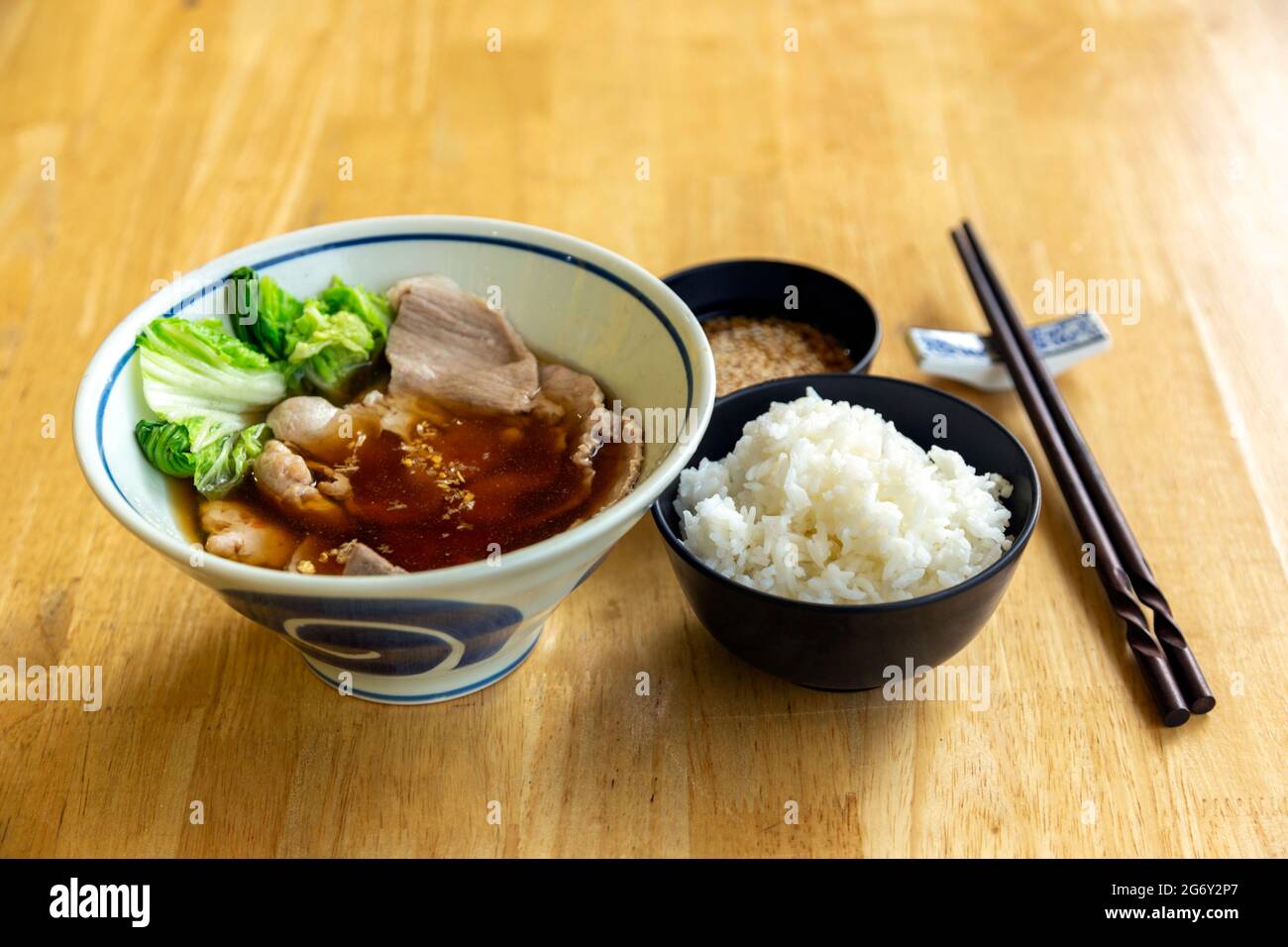 Japanese soup with pork serve with rice and suki-yaki sauce on wood ...