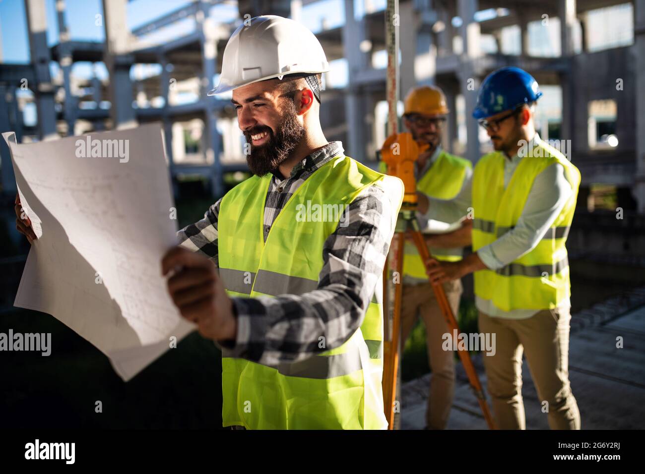 Construction engineers discussion with architects at construction or ...