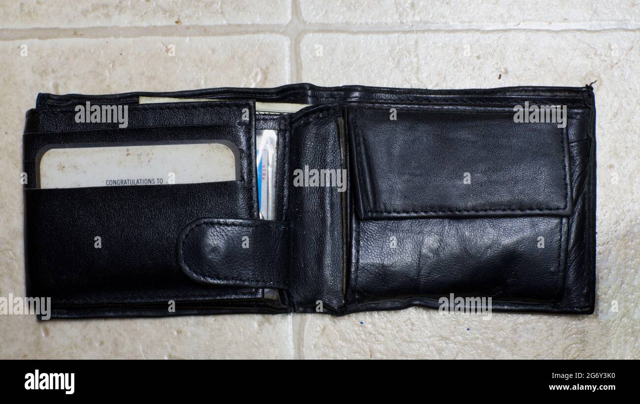 An Opened Wallet With Cash Peeking Out Slightly Stock Photo - Alamy