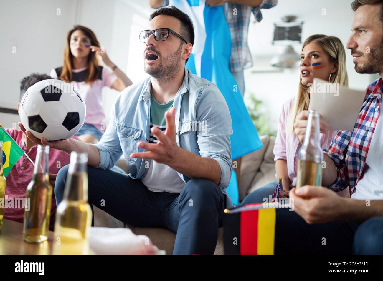 Group of football fans disappointed and happy watching a football game ...