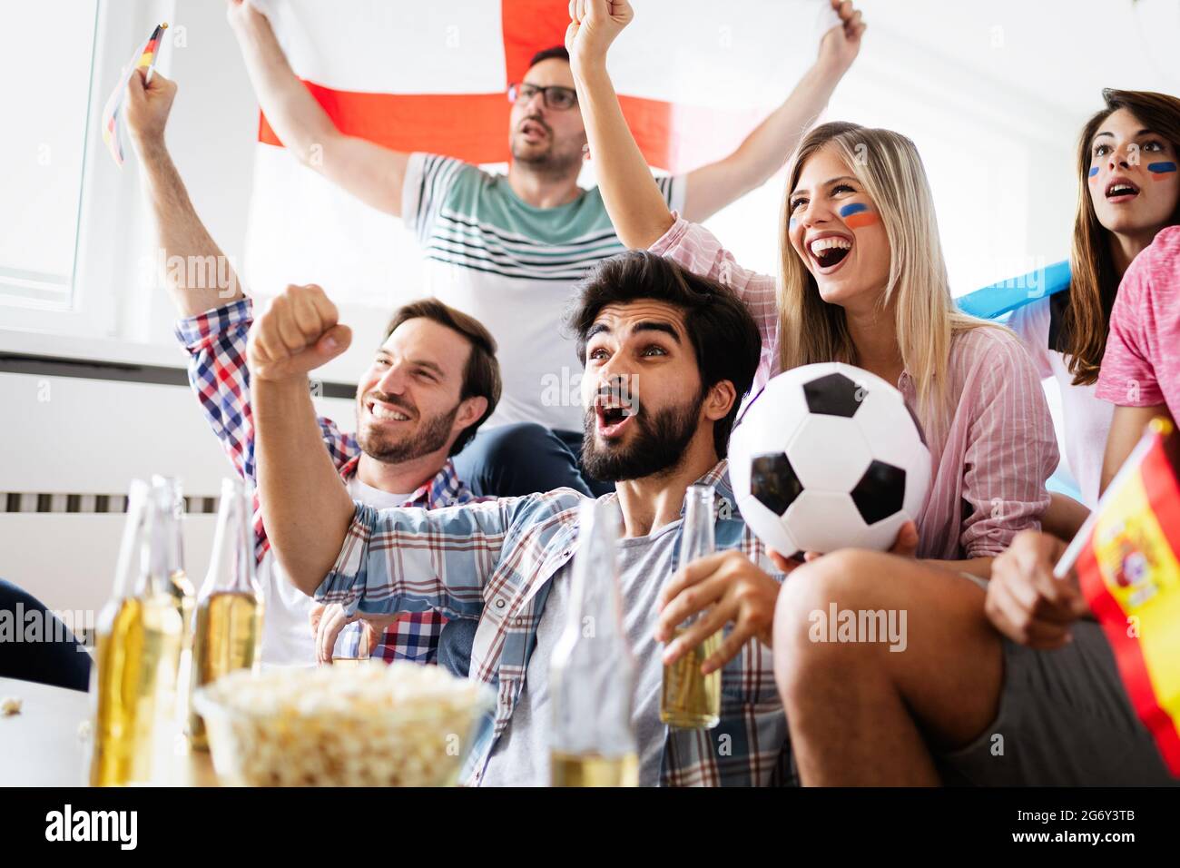 Group of friends having fun at home, watching game and enjoying ...