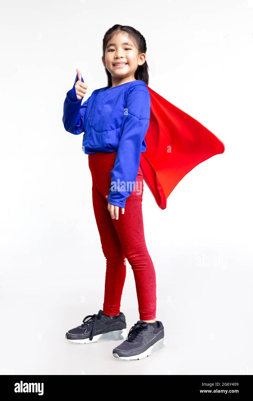Little asian child plays superhero. girl on the background with super ...