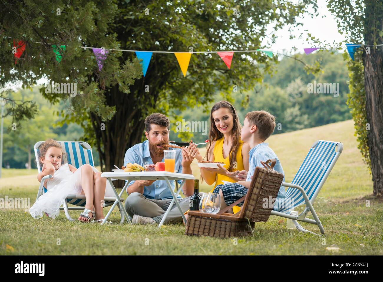 Dedicated young parents of two children listening to their funny son ...