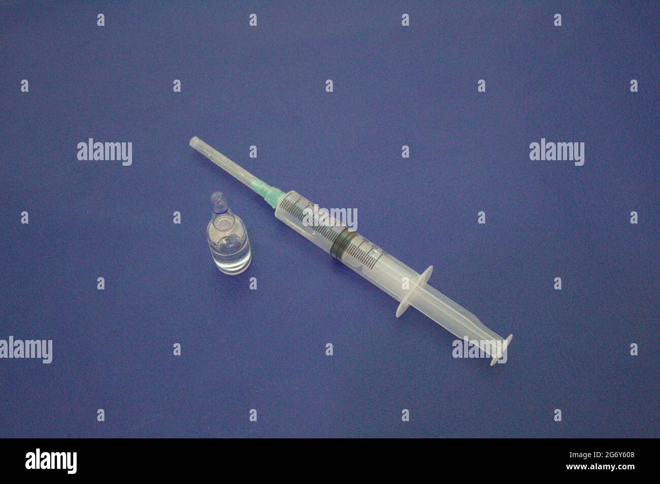 Top view of syringe and medicine ampule isolated on blue background ...