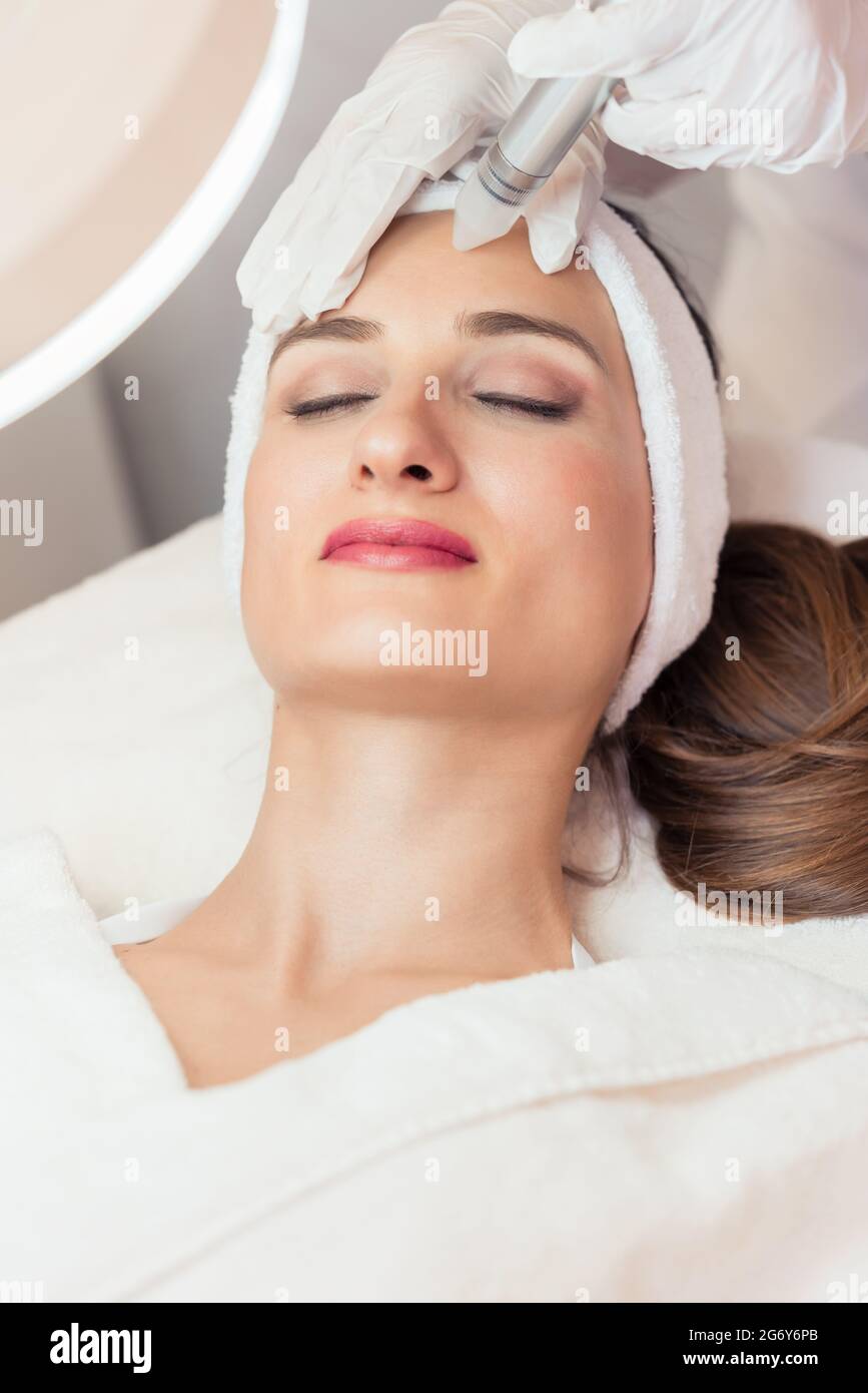 Close-up of the face of a beautiful woman smiling during innovative ...