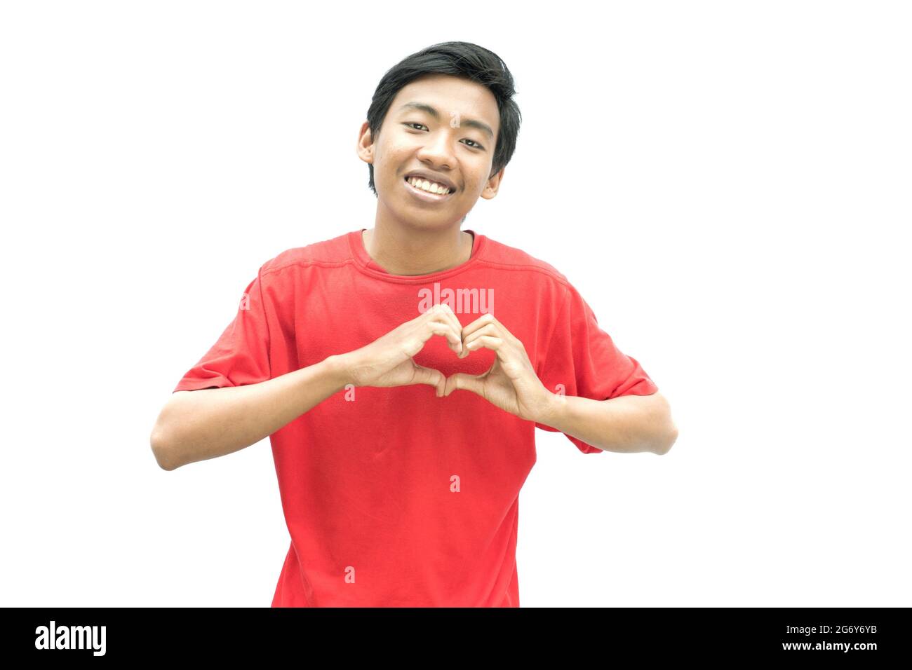 Happy young guy showing a heart with hands Stock Photo - Alamy