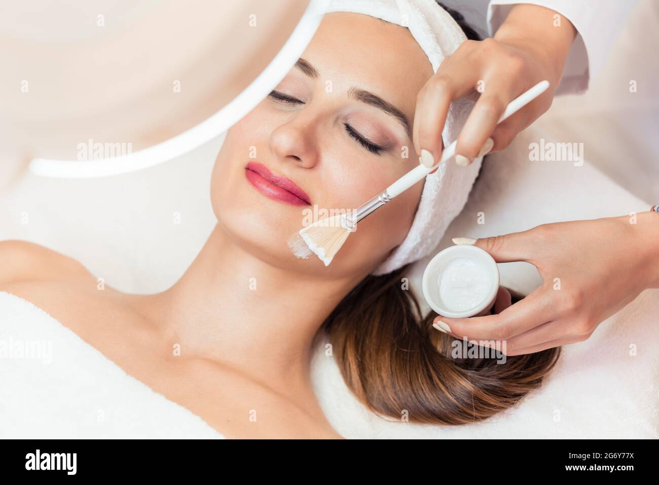 Close-up of the face of a beautiful woman relaxing during facial ...