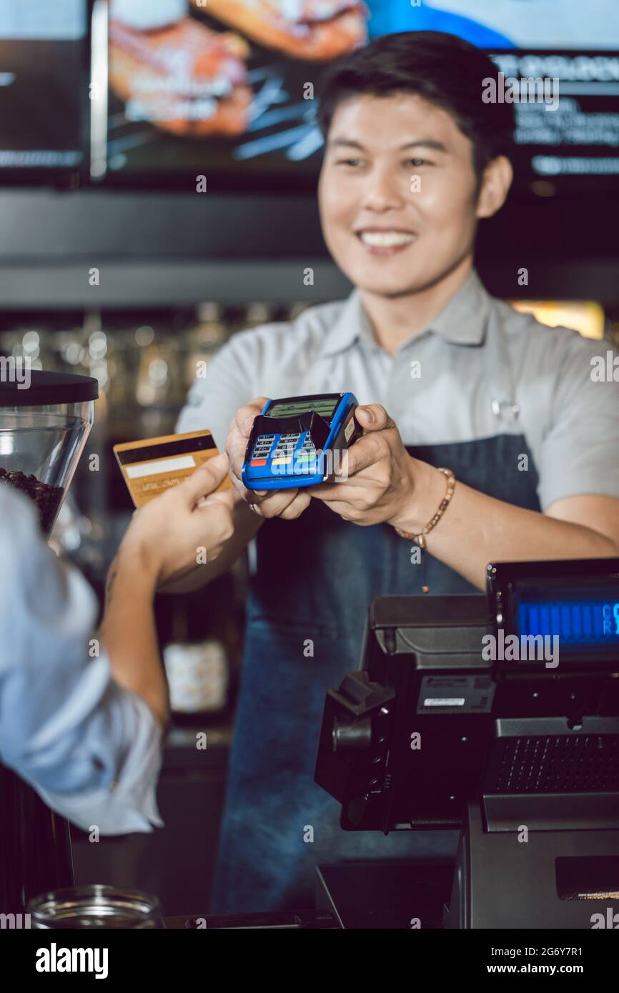 Woman making electronic payment cafe hi-res stock photography and ...
