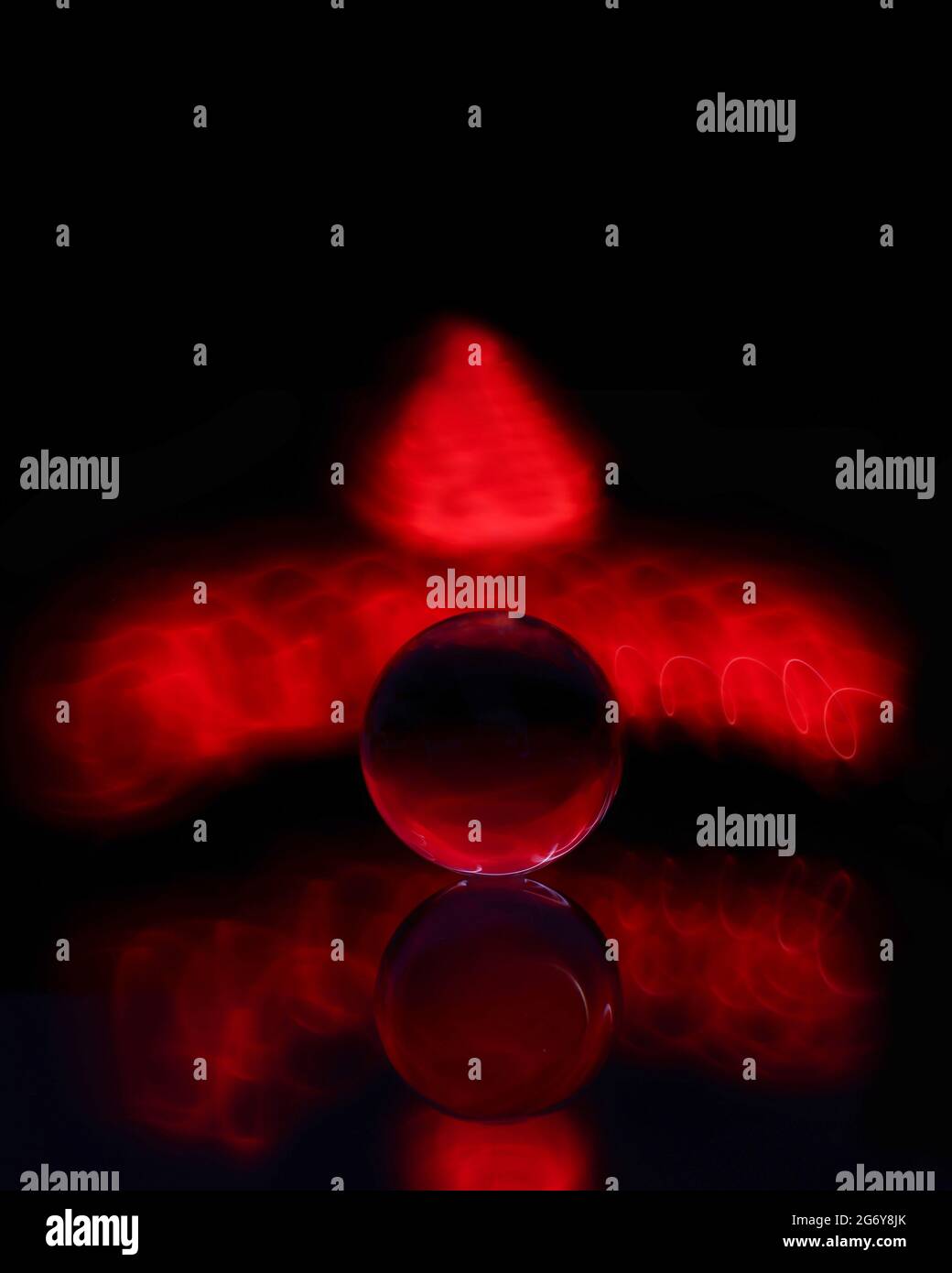 Vertical shot of red light painting through lens ball Stock Photo - Alamy