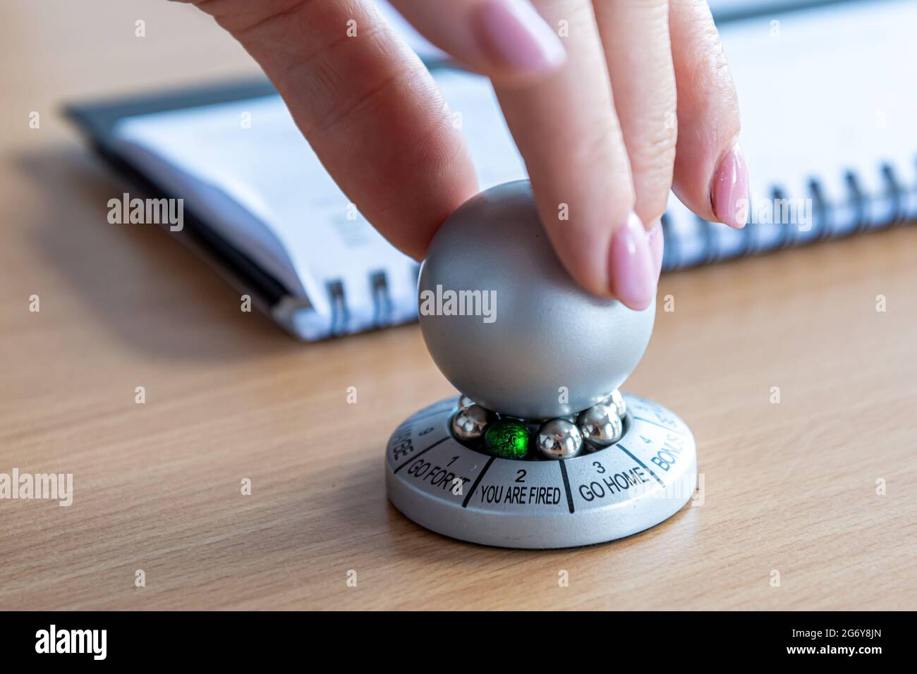 hand spinning the wheel of opportunity, pointer on YOU ARE FIRED ...