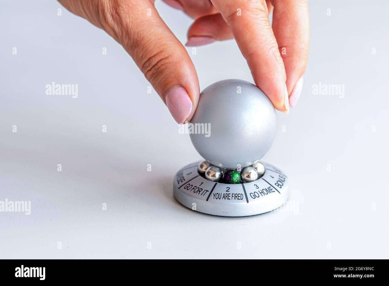 hand spinning the wheel of opportunity, pointer on YOU ARE FIRED ...