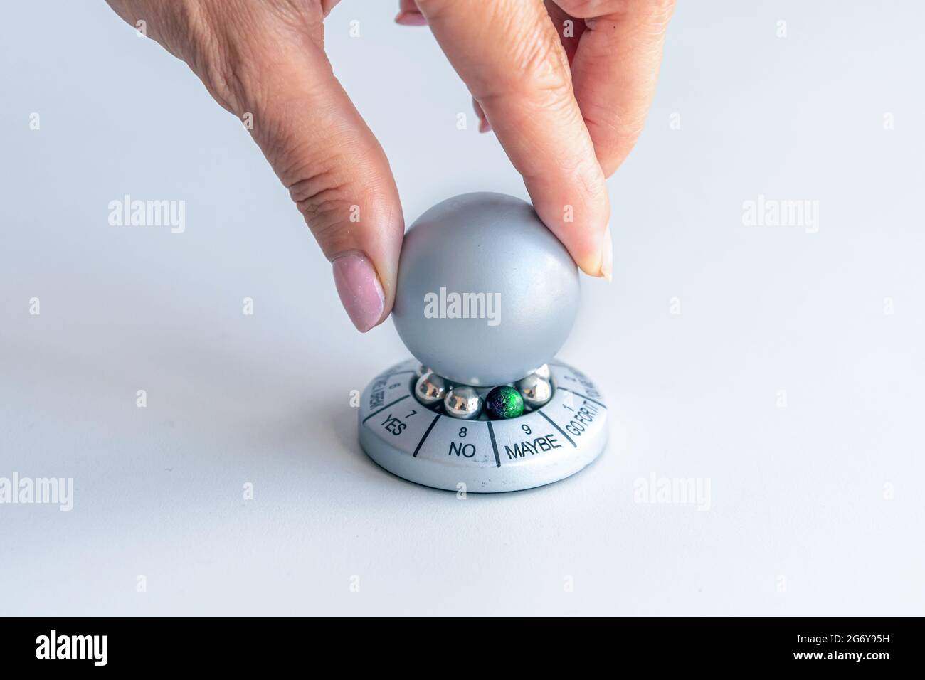 hand spinning the wheel of opportunity, pointer on MAYBE, accidental ...