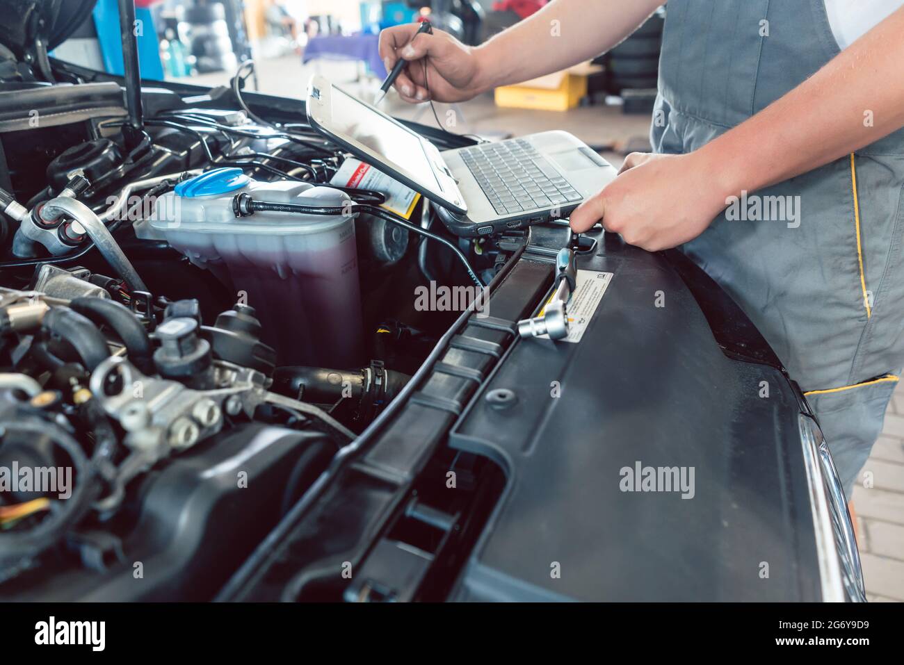 Close-up of a screwdriver held by a skilled mechanic, before repairing ...