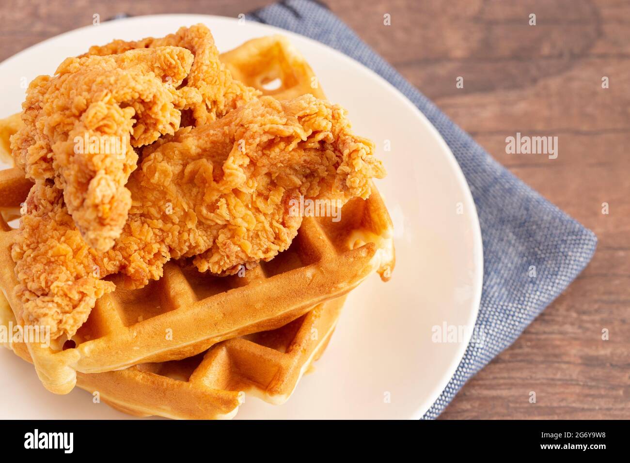 A Pile of Chicken and Waffles on a Rustic Wooden Counter Stock Photo ...